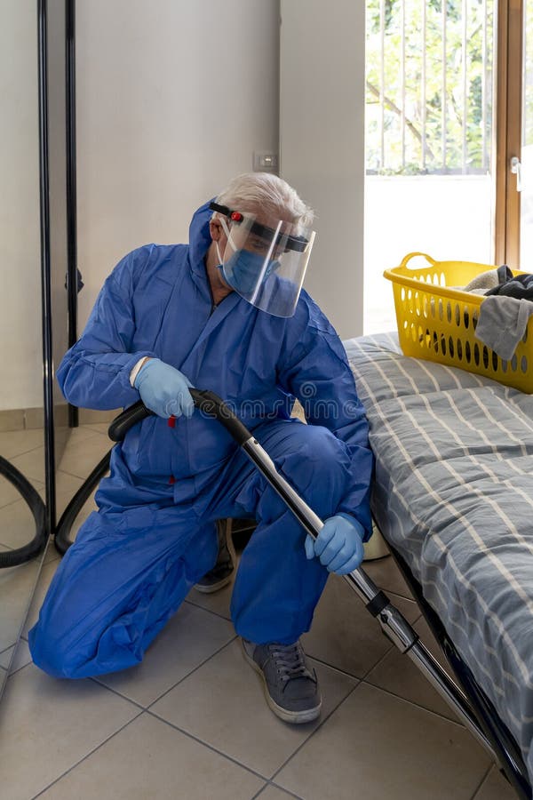 Single Man in Quarantine Dressed in Protective Suit is Cleaning House ...