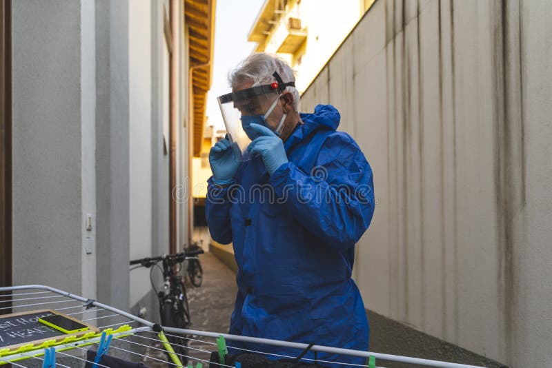 Single Man in Quarantine Dressed in Protective Suit is Doing Laundry ...