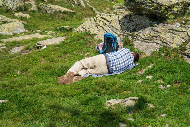 Single Man Sleeping on the Grass Surrounded by Rocks Stock Image ...