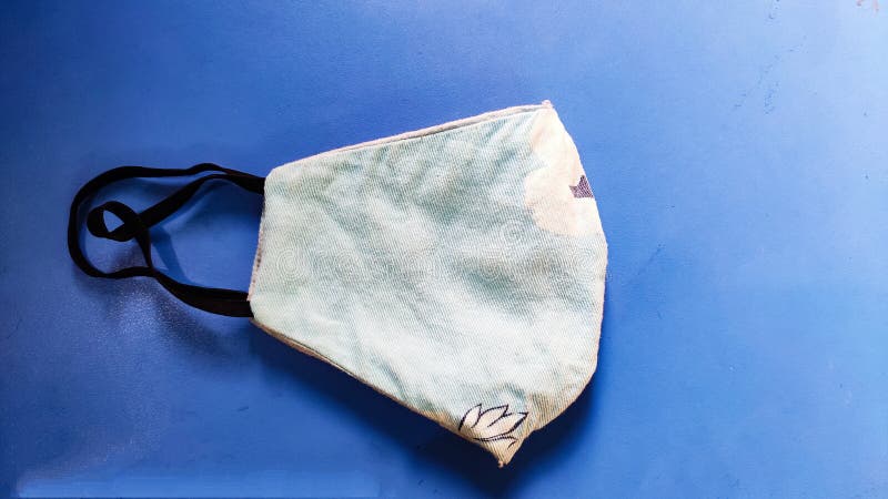 Single mask on blue table stock photo. Image of medical - 214704118