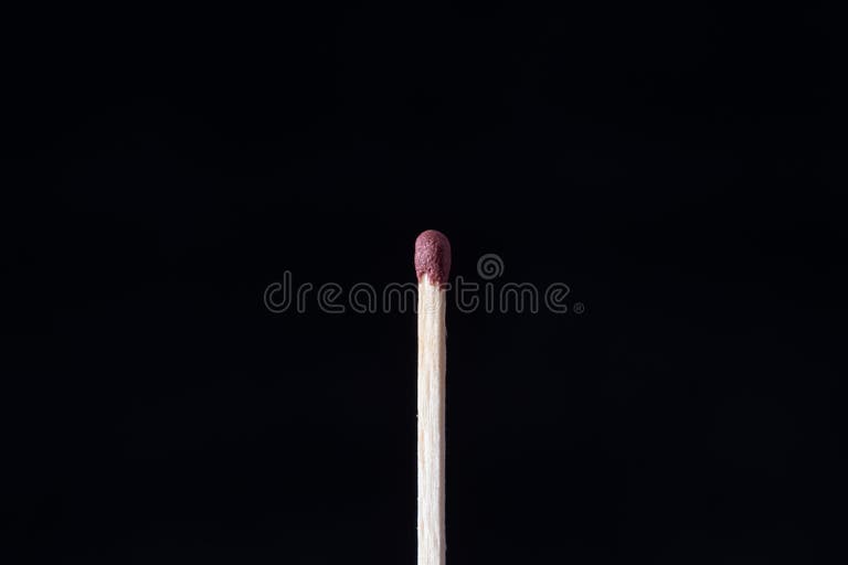 A Single Matchstick Stands Upright Against a Solid Black Background ...