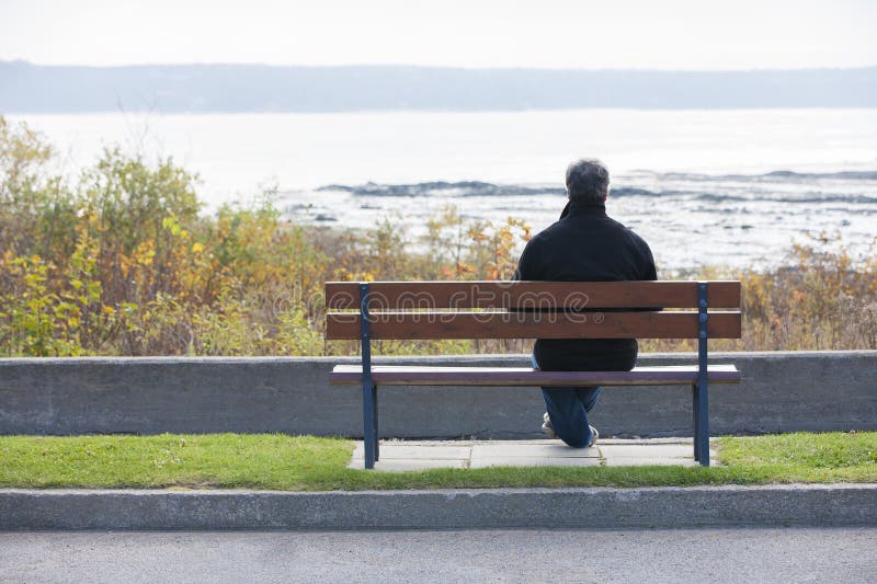 Single Mature Man Sitting on Park Bench Overlooking River in Autumn ...