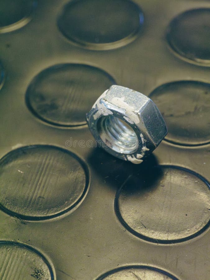 Single Metal Nut Resting on Textured Surface Stock Image - Image of ...