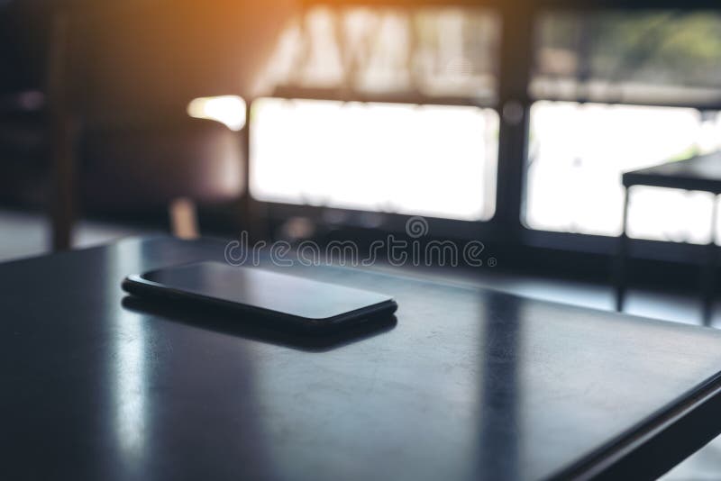 A Single Mobile Phone on Table Stock Photo - Image of desk, edge: 141928594