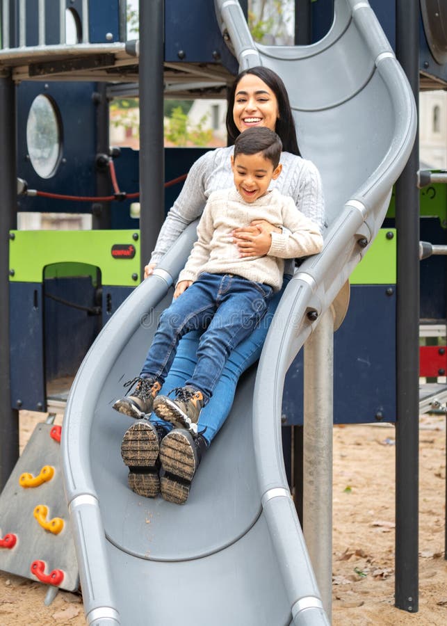 Single Mother and Son Having Fun Together in a Slide in a Playground ...
