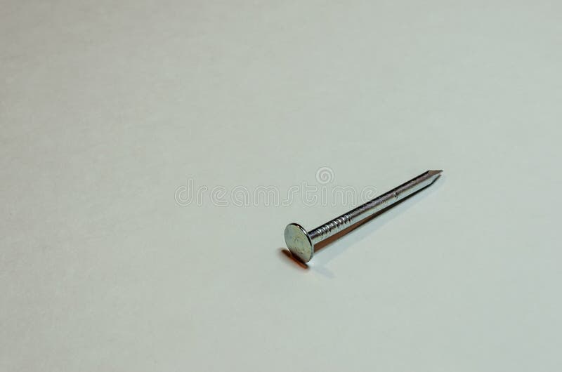 Single Nail Pointing To the Upper Left on White Stock Image - Image of ...