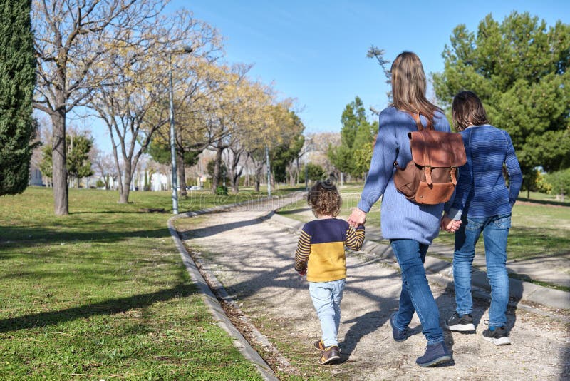 Single-parent Family Walking in a Park, View from Behind Stock Image ...