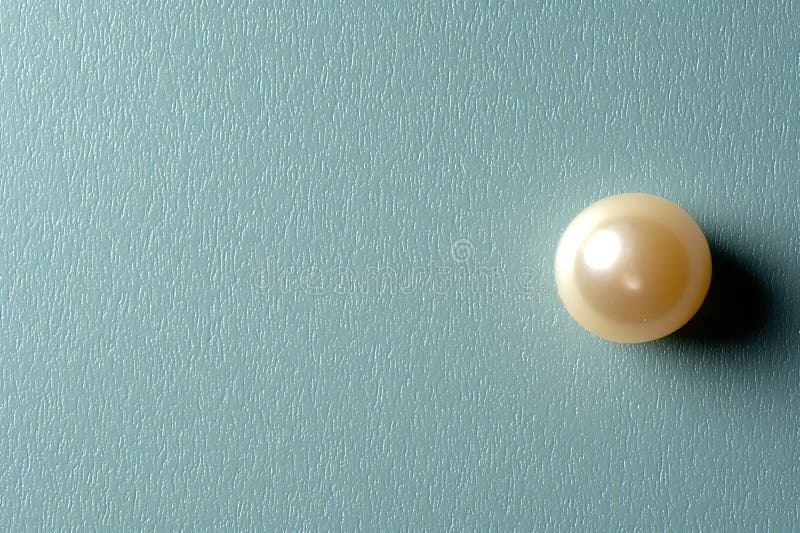 Single Pearl on Textured Blue Background Elegant Still Life Image Stock ...