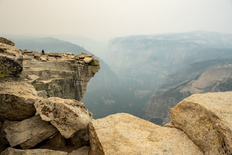 Single Person Sits on the Rocky Edge of Half Dome Stock Image - Image ...