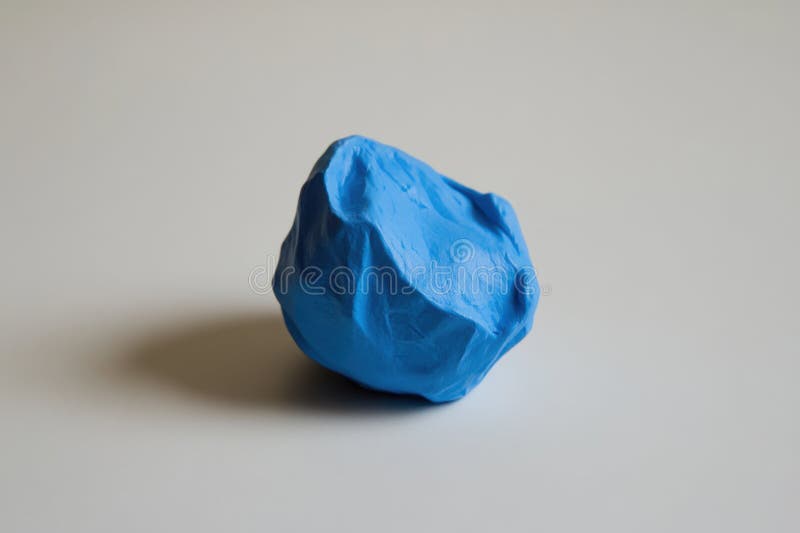 A Single Piece of Blue Plasticine Sculpted into a Compact Shape on a ...