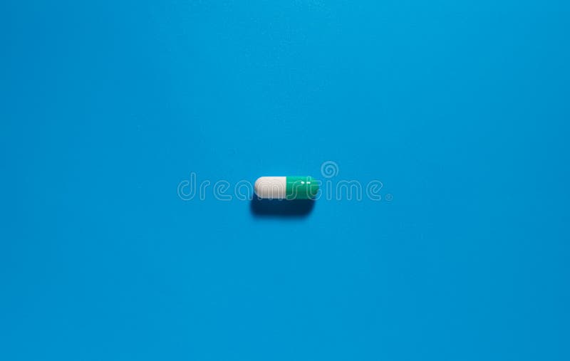 Single Pill on Blue Background Stock Photo - Image of drug, background ...