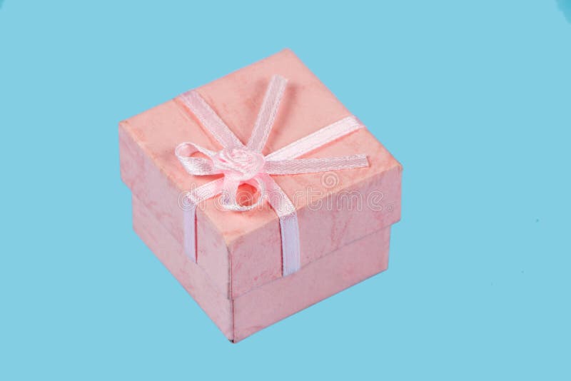 Single Pink Gift Box with Pink Ribbon on Blue Background Stock Image ...