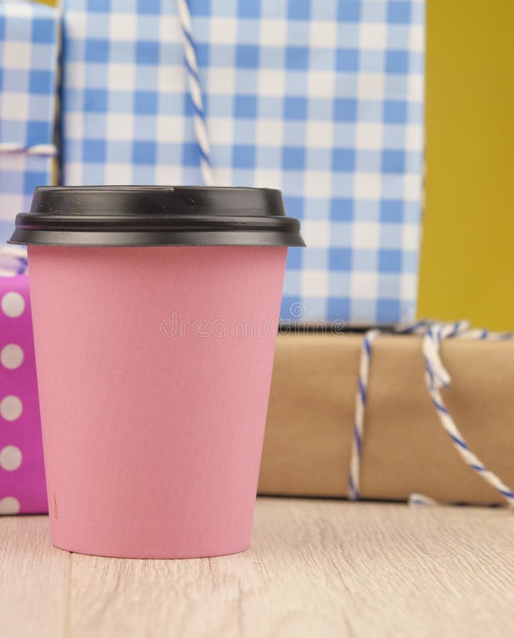 Single Pink Paper Cup of Coffee and Heap Gift Boxes Stock Image - Image ...