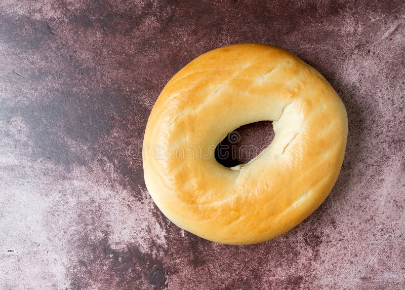 Single Plain Bagel on a Red Mottled Countertop Top View Stock Image ...