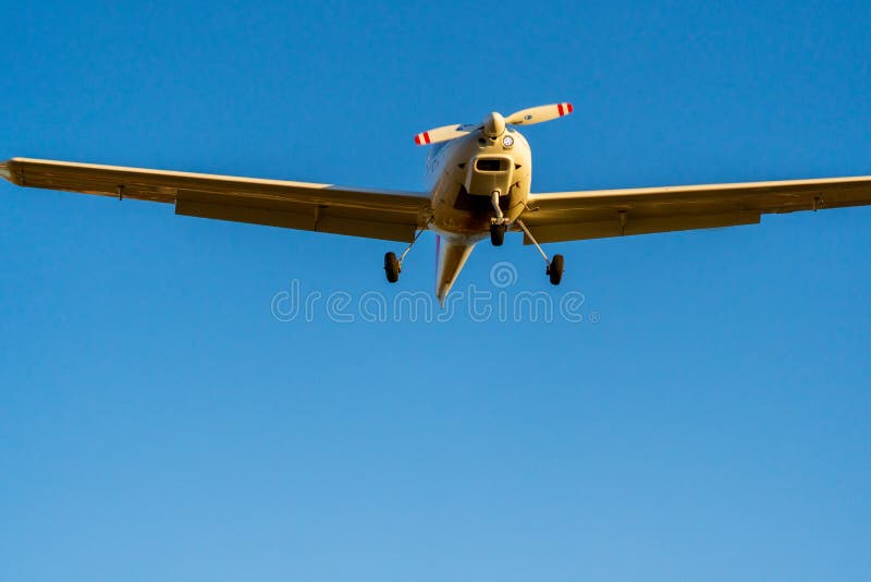 Single-propeller Plane Landing from a Front View at Sunset. Stock Photo ...
