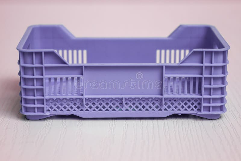 Single Purple Plastic Crate Set Against a Pink Background Stock Image ...
