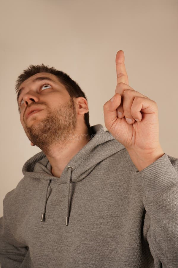With a Single Raised Finger, the Man Points Upward To Underscore a ...