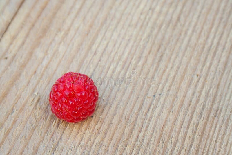 Single raspberry on wood stock photo. Image of summer - 122502928