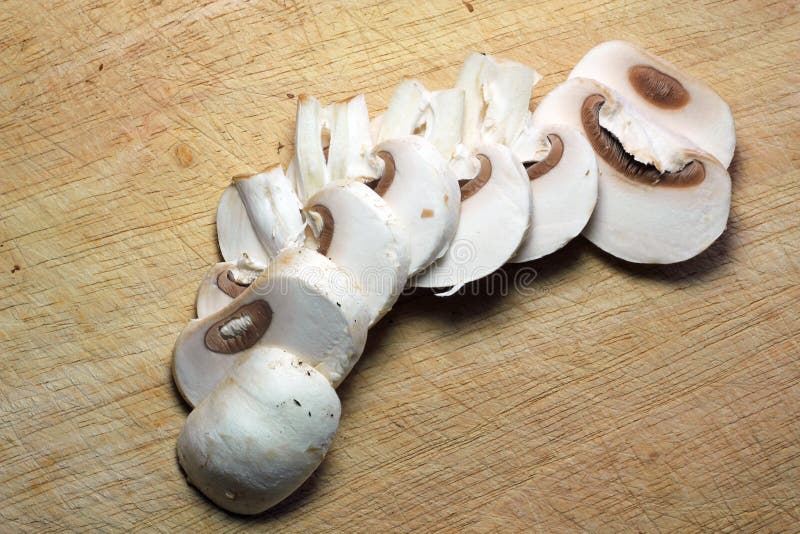 Single Raw Button Mushroom in Slices on a Board. Stock Image - Image of ...