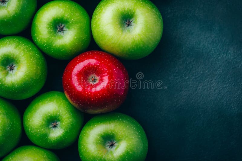 A Single Red Apple Contrasts Against Several Green Apples from a Top ...