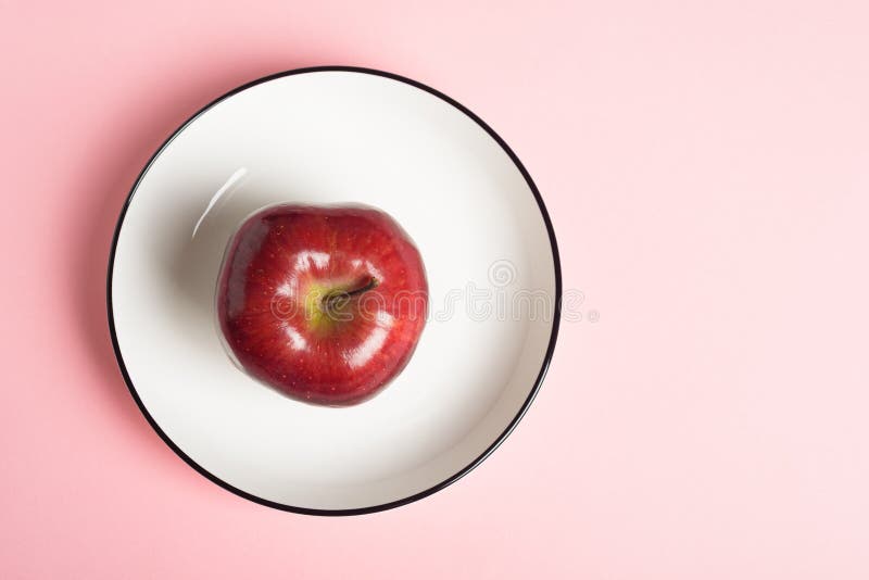 Single Red Apple on White Plate, Pink Background Stock Photo - Image of ...