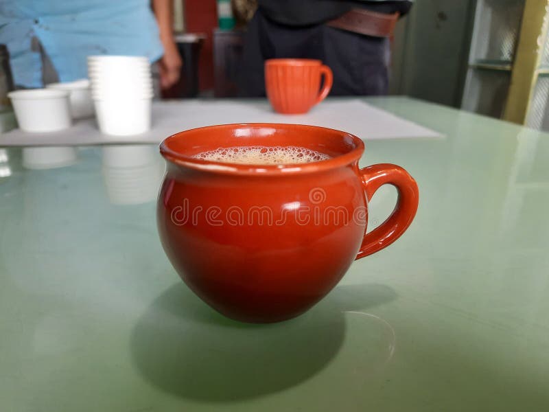 Single Red or Brown Color Clay, Sand Coffee Cup on a Table Stock Image ...