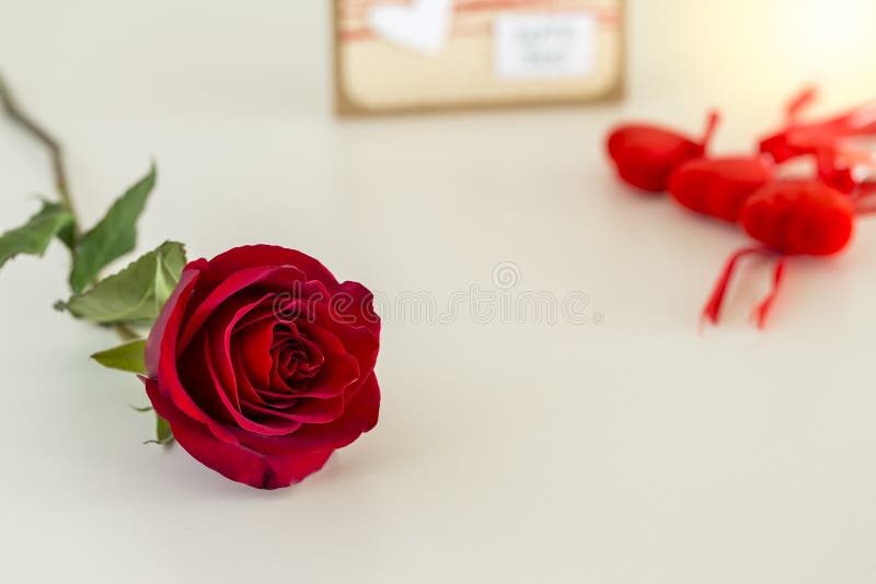 Single Red Rose, Hearts, and Card on Table Stock Photo - Image of ...