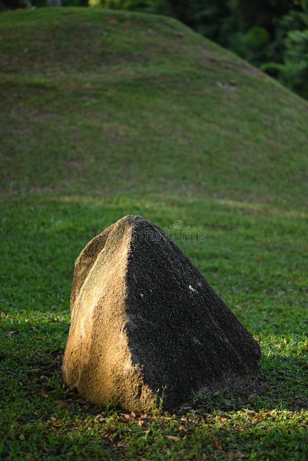 A Single Rock on Grass Field Stock Photo - Image of sculpture, granite ...