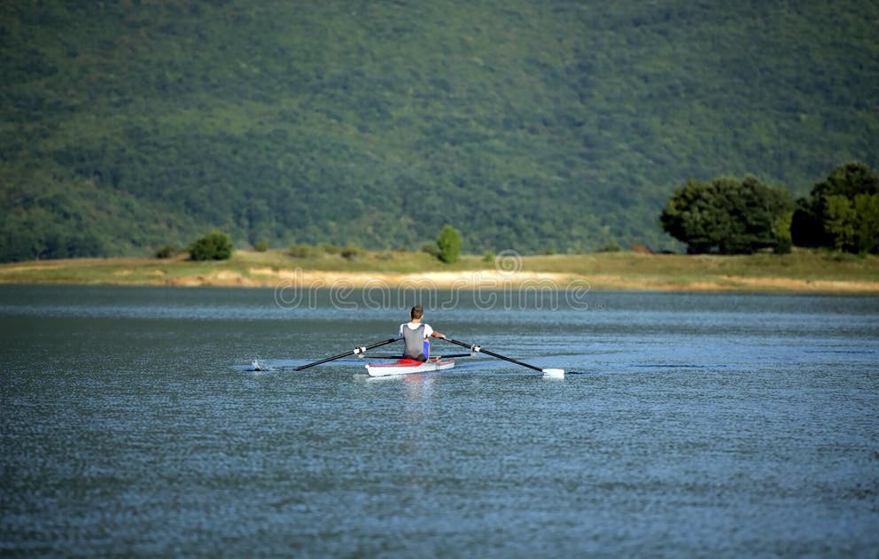 Single rower at sunrise stock photo. Image of hobby, oars - 86111994