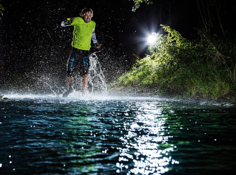 Single Runner Running in Rain and Making Splash in Puddle Stock Image ...