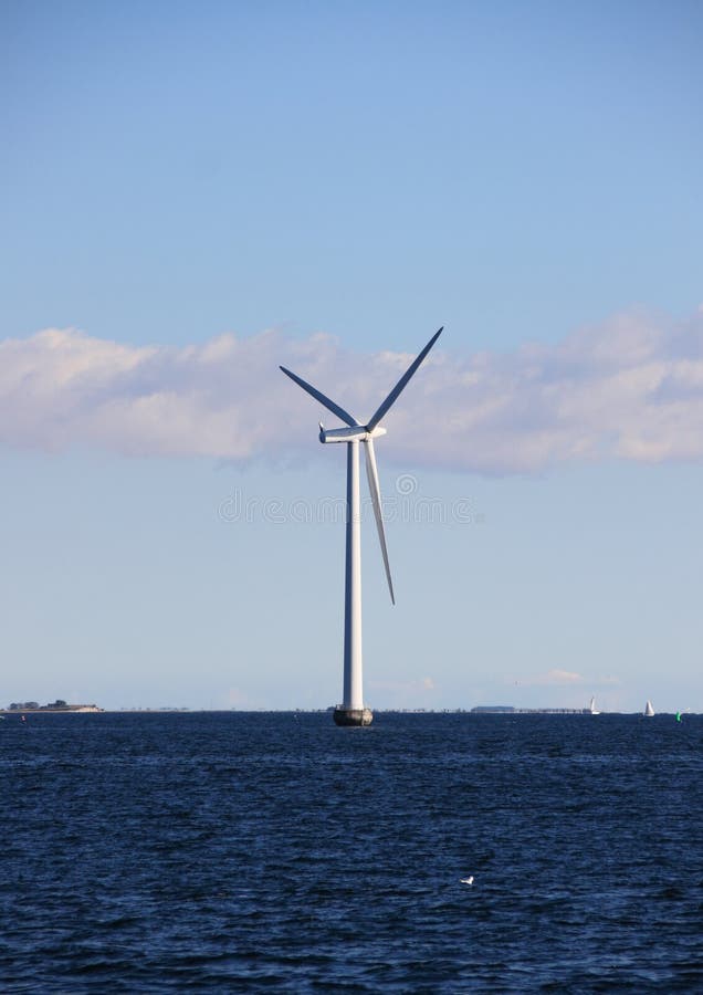 Single Sea Windmill with Dark Blue Water and Clouds Stock Photo - Image ...