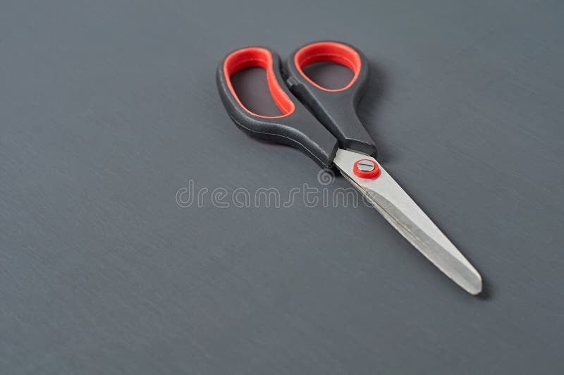 Single Sharp Scissors with Plastic Handle Black and Red Colors Lies on ...