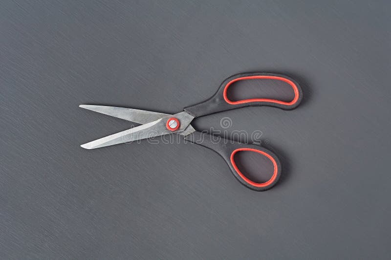 Single Sharp Scissors with Plastic Handle Black and Red Colors Lies on ...