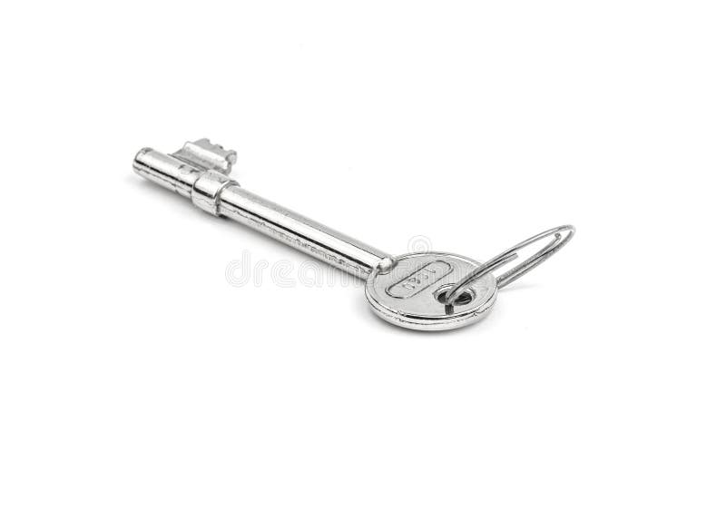 A Single Silver Colored Key with a Round Head and a Key Ring Attached ...