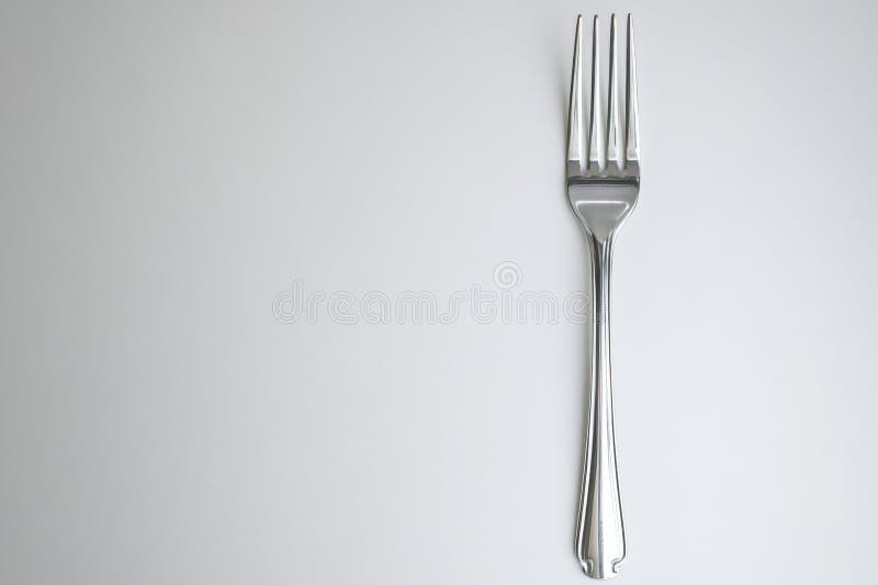 A Single Silver Fork Stands Isolated on a Pristine White Background ...