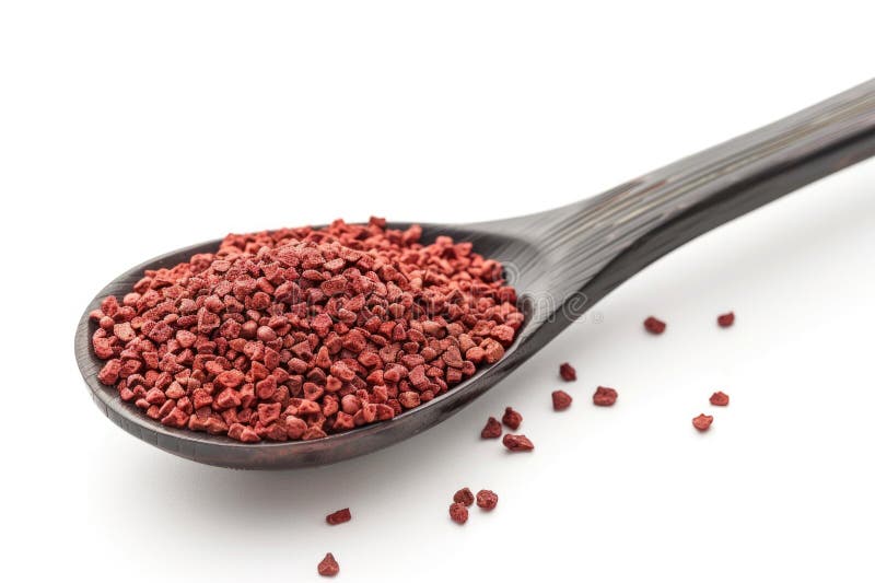 A Single Spoon Filled with Red Granola Sitting on a White Surface Stock ...