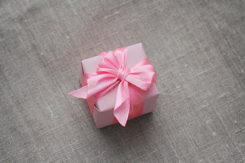 Square Box Wrapped in Brown Kraft Paper and Tied with a Silk Red Ribbon ...