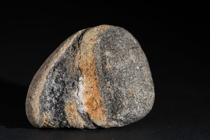 Single Stone with Red and Brown Geological Pattern Isolated on Black ...