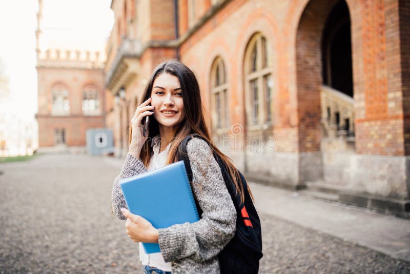 Single Student Walking and Reading Mobile Phone Messages with a ...