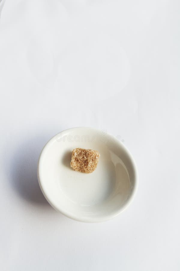 Single Sugar Cube Left in a Small Bowl on White Background Stock Photo ...