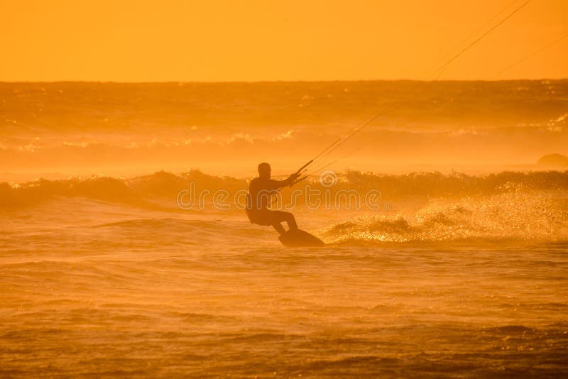 Surfer at Sunset on a Calm Ocean Stock Photo - Image of backlight ...