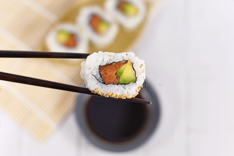 Single Sushi Inside Out Roll with Salmon, Avocado and Sesame Stock ...