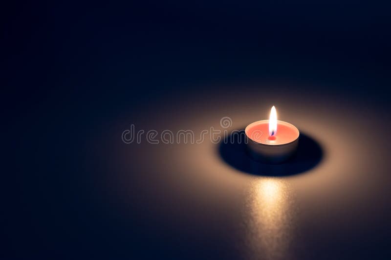 Single Tealight Candle Burning in Darkness Stock Image - Image of ...