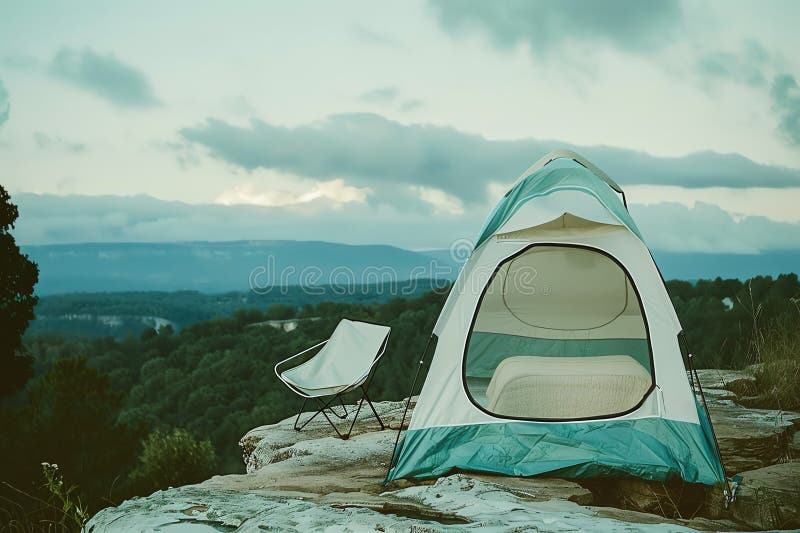 A Single Tent and Chair Set Up on a Mountain Top Overlooking a ...
