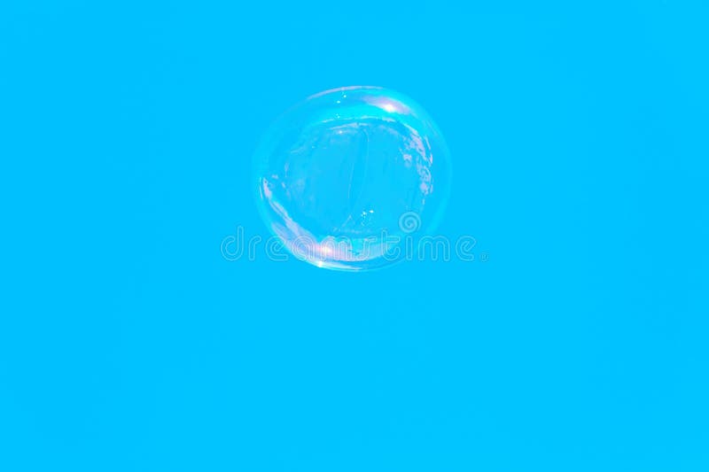 Single Transparent Bubble Floating Against Blue Background Stock Photo ...