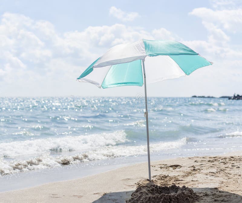 Single Umbrella On The Beach Stock Photo - Image of clouds, ocean: 97789916