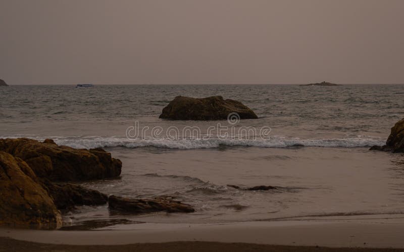 Single Wave Coming through the Two Rocks at Seashore Stock Photo ...