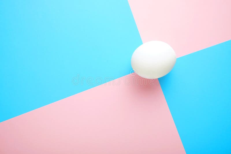 Single White Egg on Crossing Point of Blue and Ping Backgrounds Stock ...