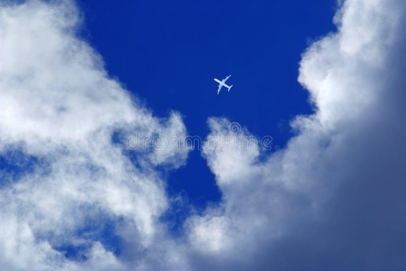A Single White Passenger Plane in the Blue Sky Stock Photo - Image of ...