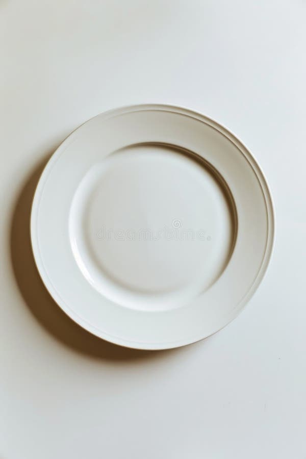 A Single White Plate Sits on a White Table Stock Image - Image of table ...